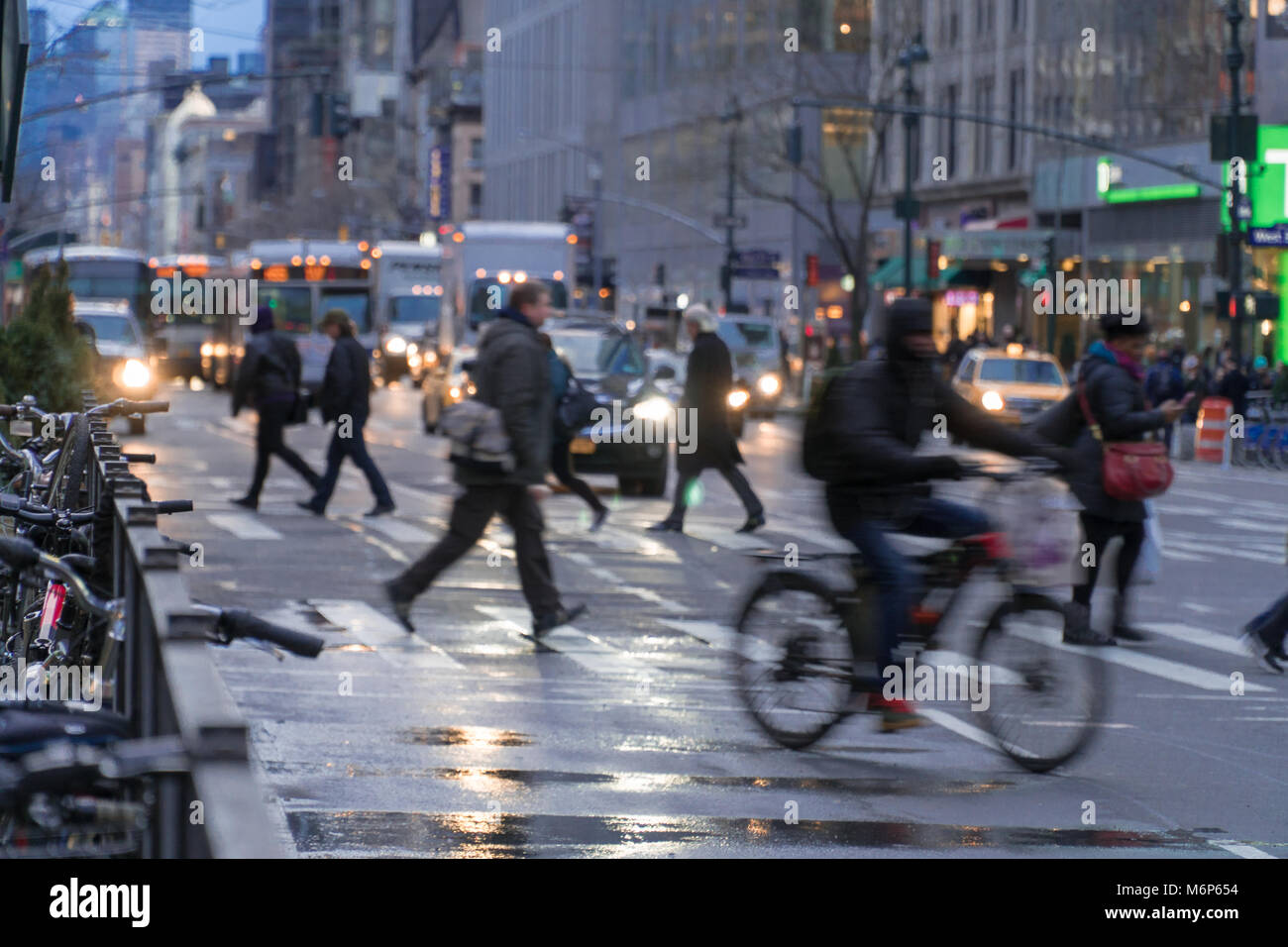 People in New York City during evening rush hour cross avenue street in ...