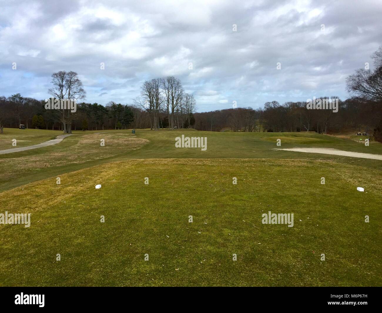 A beautiful nature view of an empty golf course in the winter. Bare ...