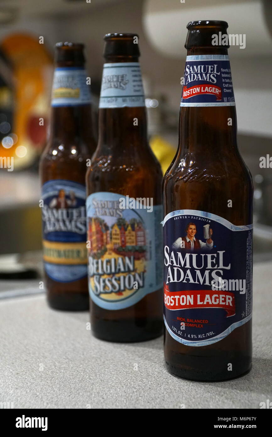 Samuel Adams variety of beer bottles sit on a kitchen counter top. Product shot. Named after ...