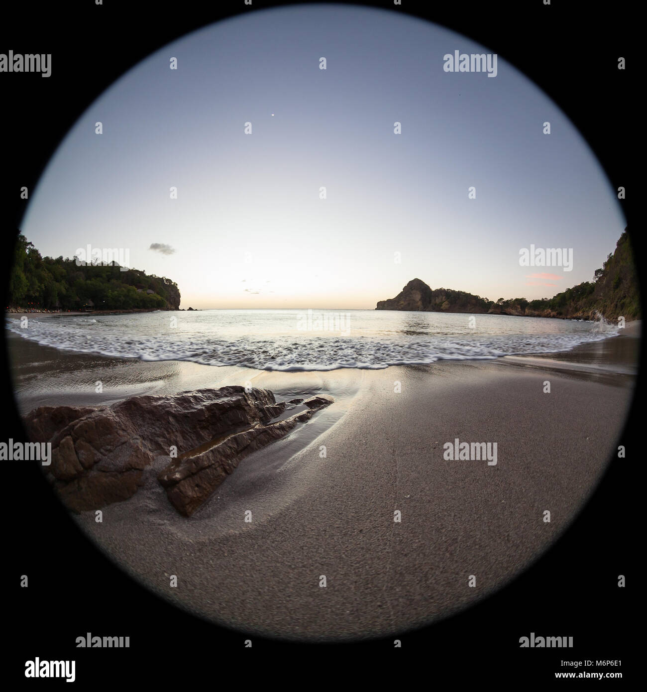 relaxing beach scene shot with a fish eye lens creating a circular ...