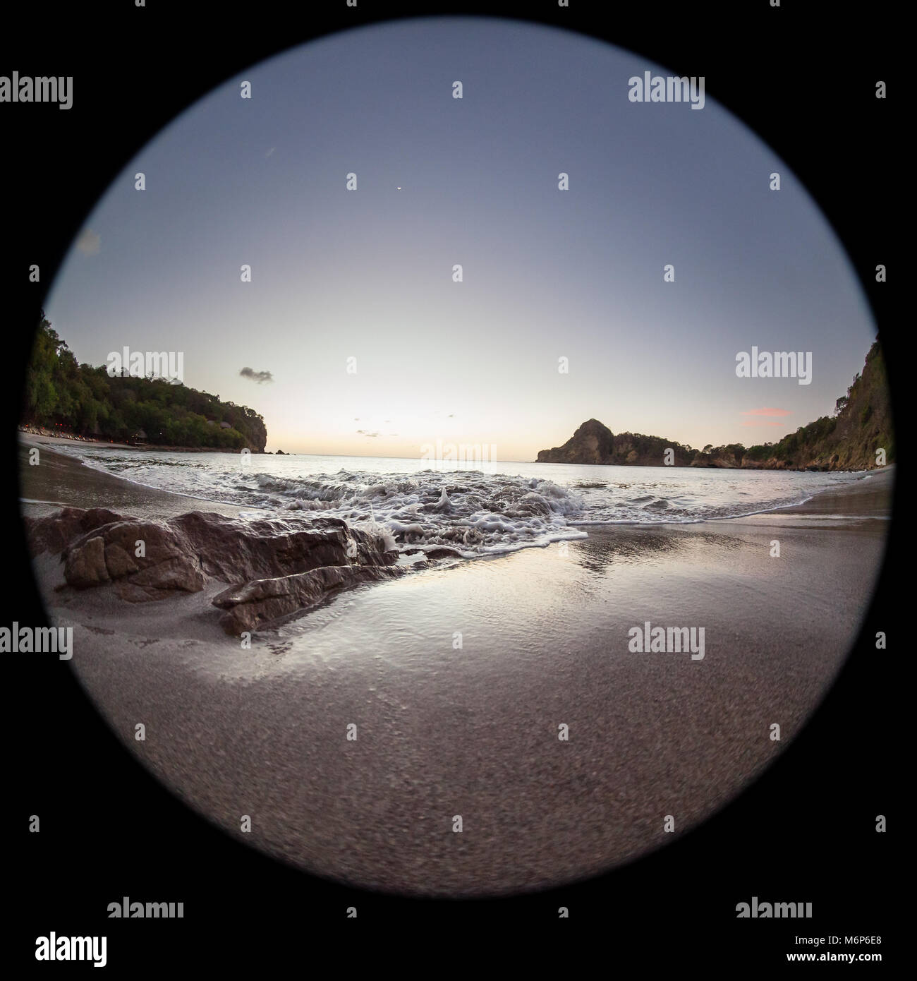 relaxing beach scene shot with a fish eye lens creating a circular ...