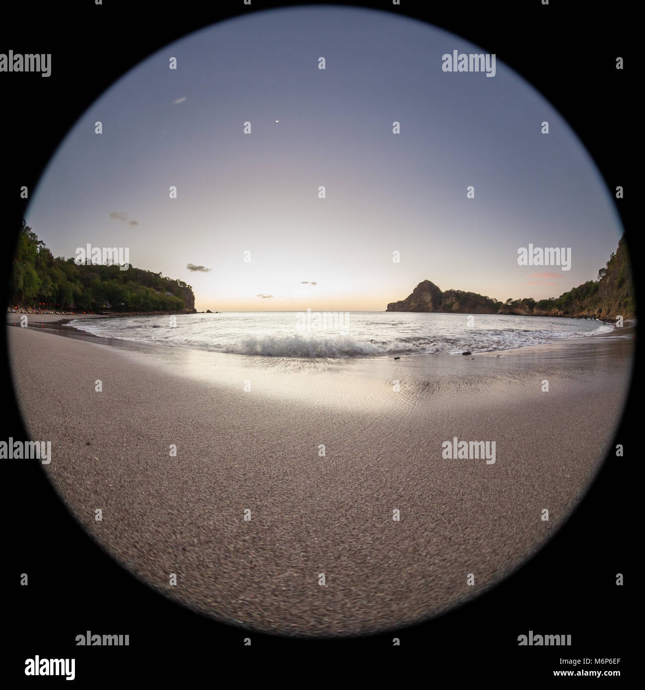 relaxing beach scene shot with a fish eye lens creating a circular ...