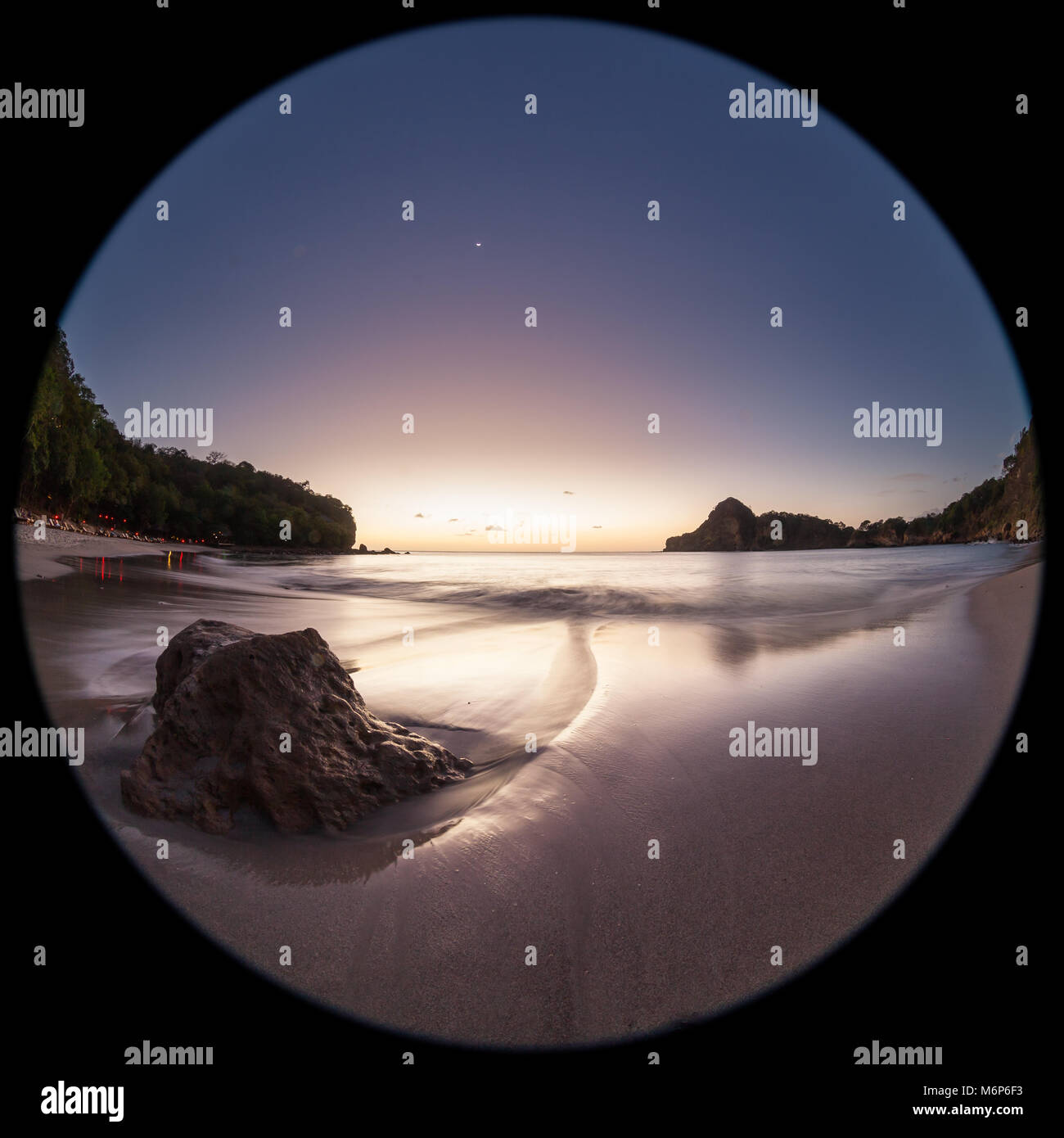 relaxing beach scene shot with a fish eye lens creating a circular ...