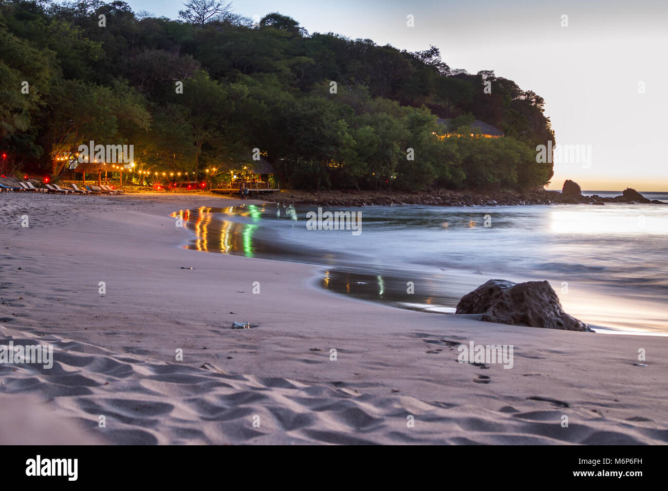 relaxing evening with a calm beach and a light blue in the sky as the ...