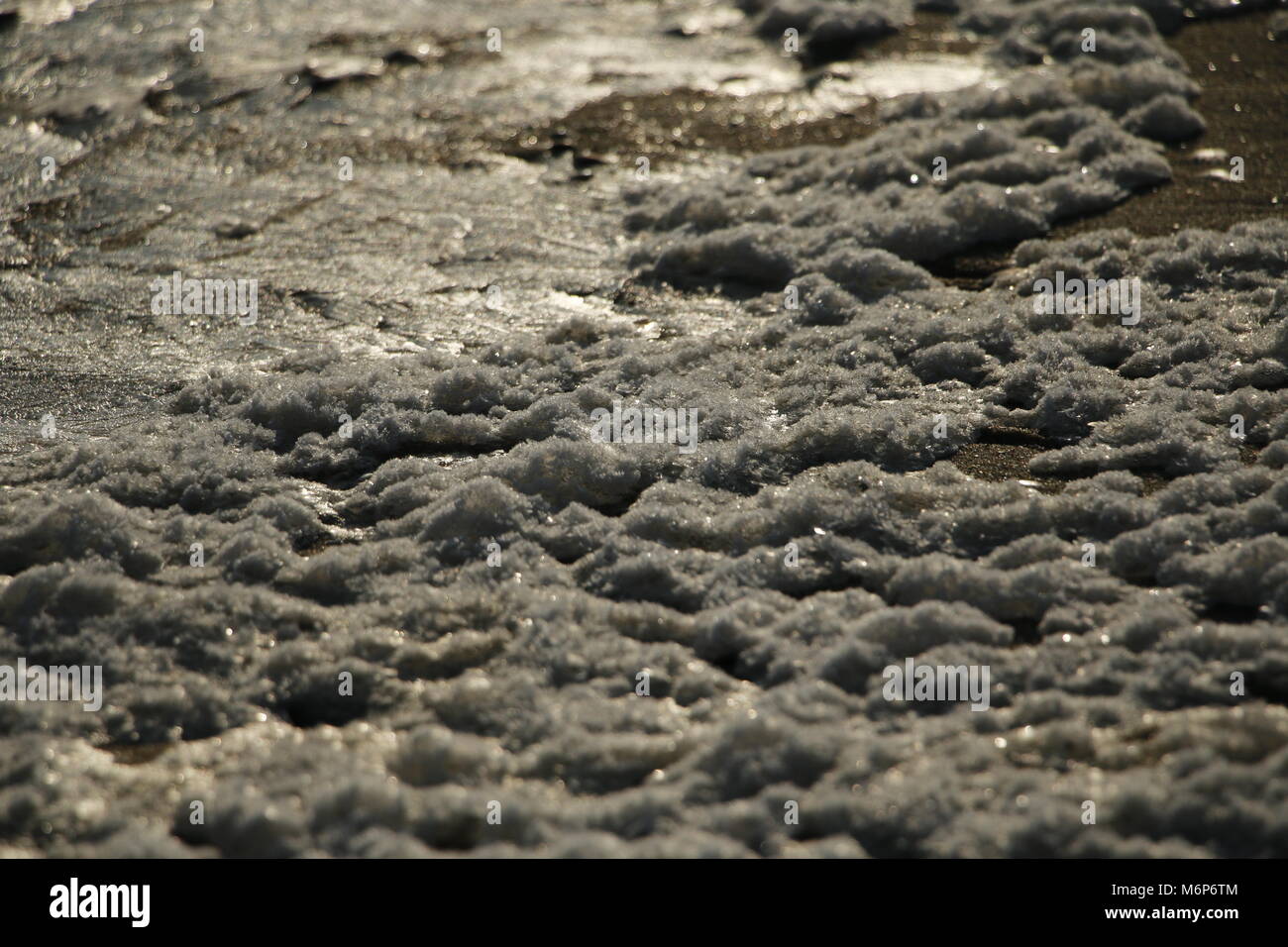 Frozen foam at the beach Stock Photo - Alamy