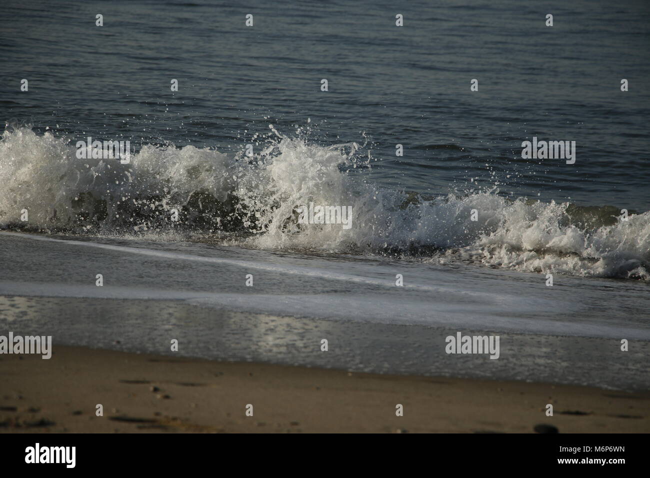A wave at the Dutch beach Stock Photo - Alamy