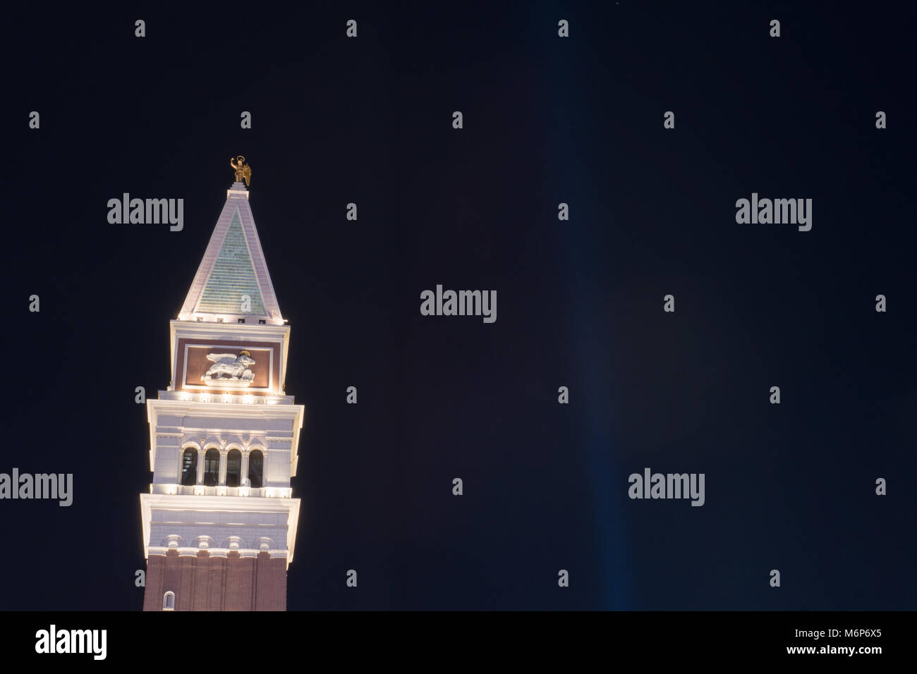 Beautiful architecture tower illuminated at night. Bright spot light ...