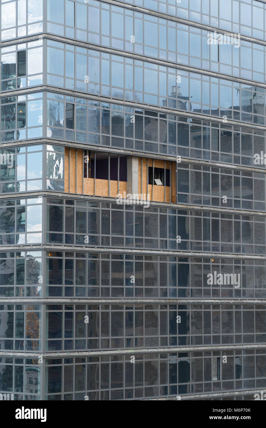 Broken glass knocked out of skyscraper building facade in urban city ...