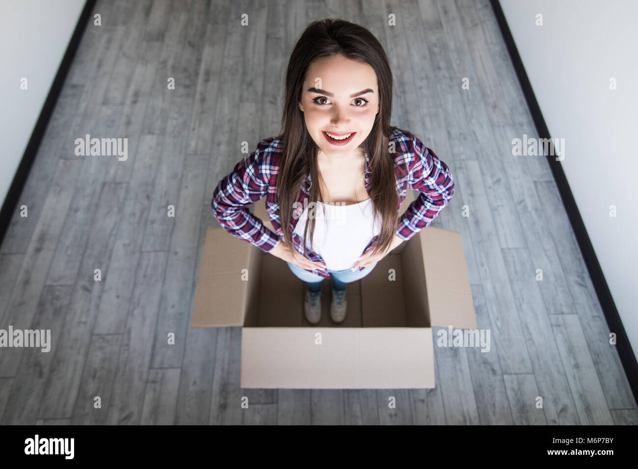 Woman sitting inside a cardboard box while packing Stock Photo - Alamy