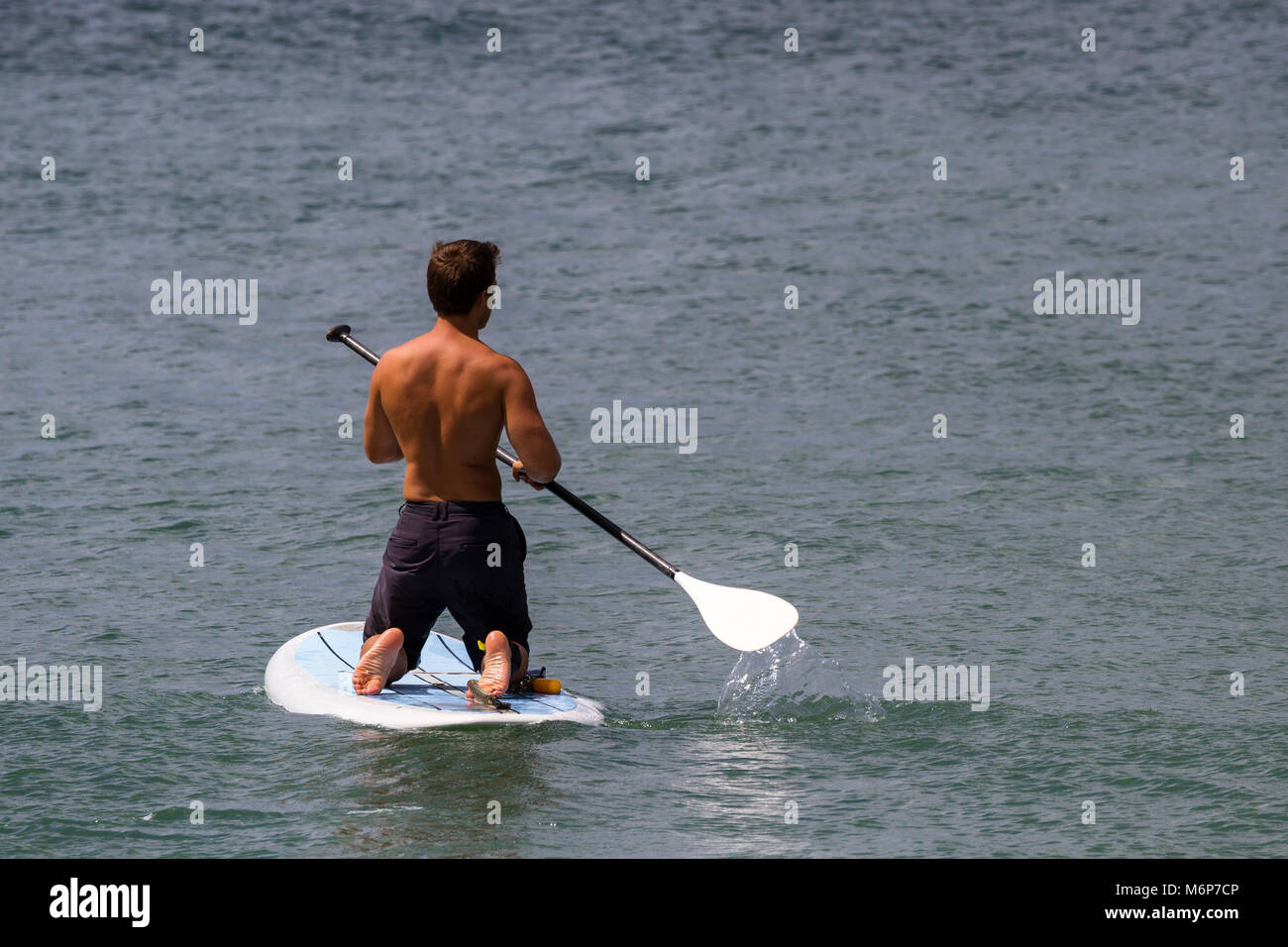 young man paddle boarding in the pacific ocean in Nicaragua Stock Photo ...