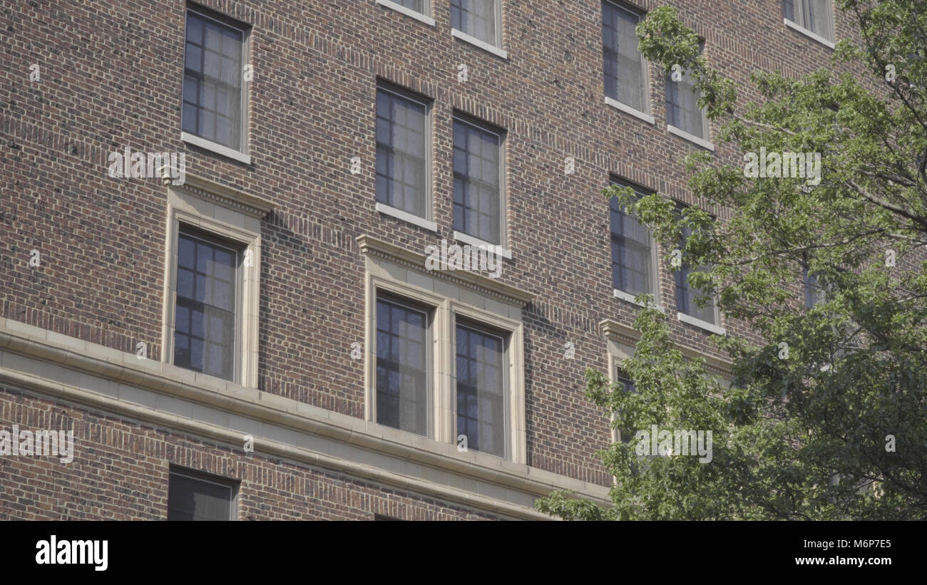 Exterior establishing shot of generic brick urban city apartment ...