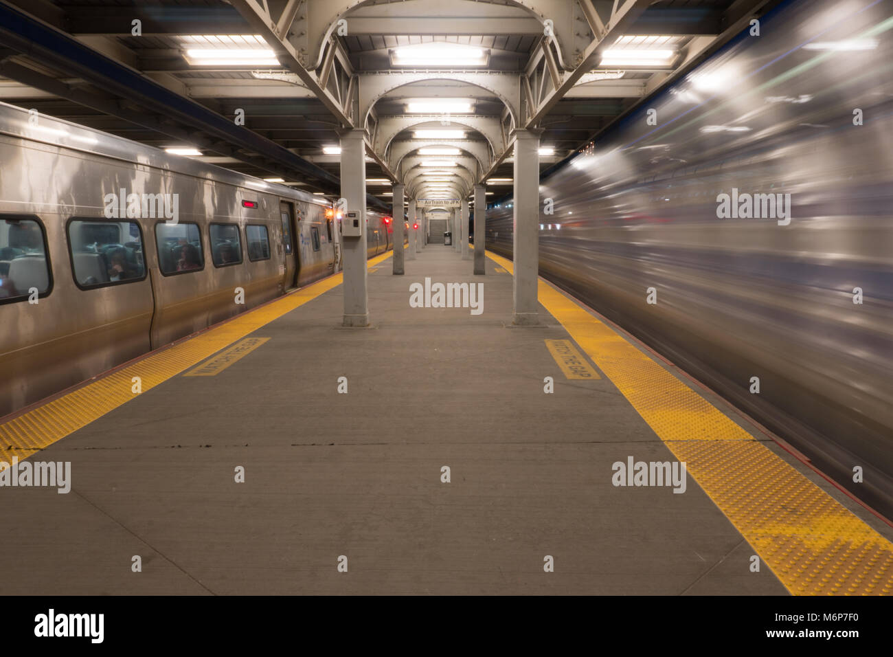 Long Exposure of high speed train passing station platform waiting ...