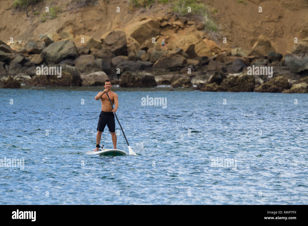 young man paddle boarding in the pacific ocean in Nicaragua Stock Photo ...