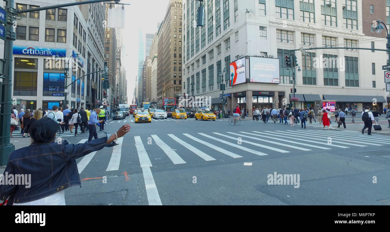 New York City, Circa 2017: Woman hail NYC yellow taxi cab during busy ...