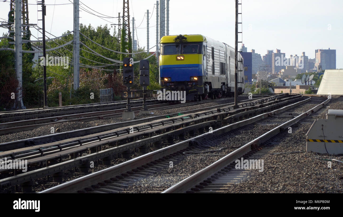 A yellow and blue diesel train engine locomotive carry passenger car ...
