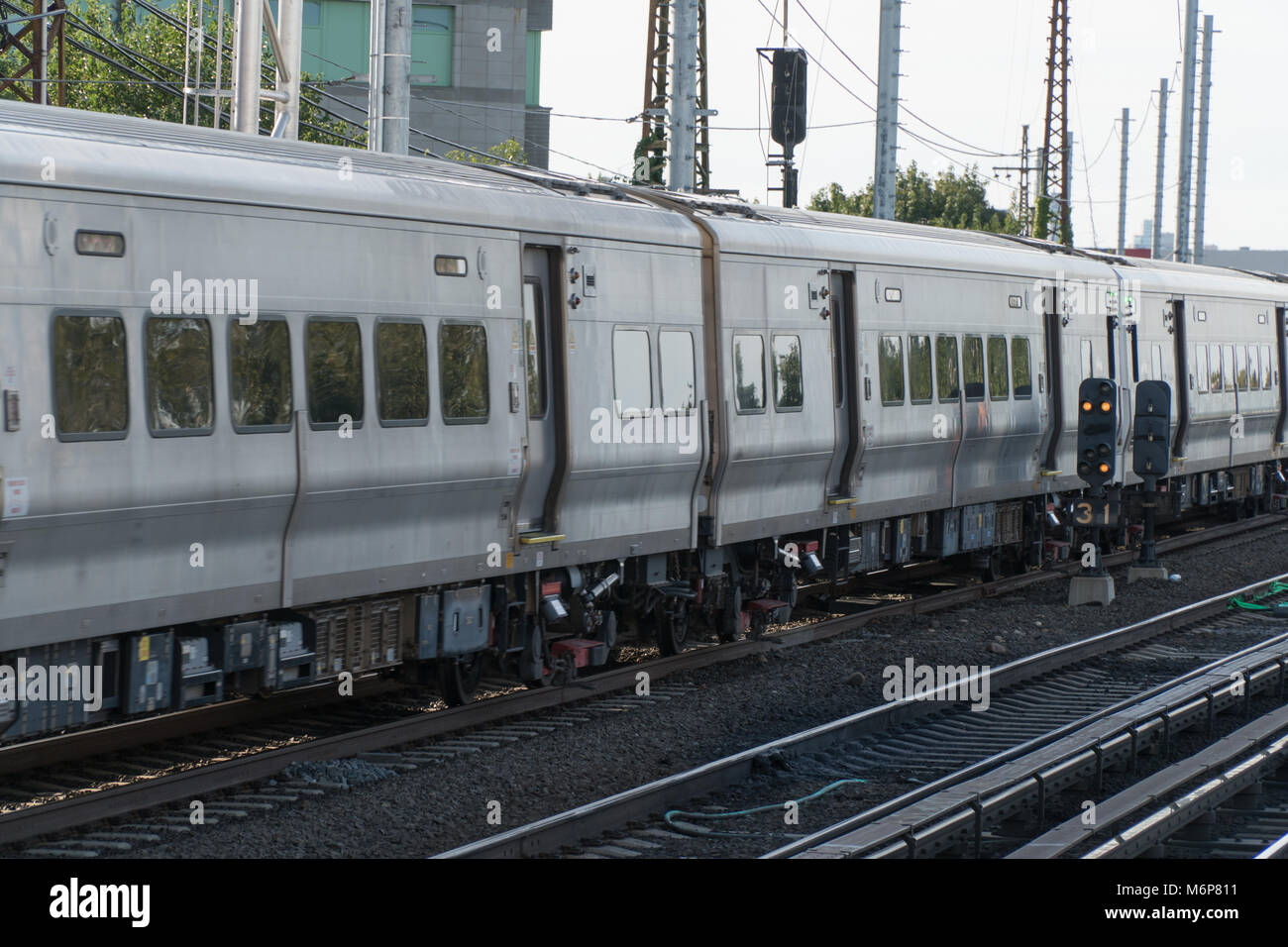 Commuter railroad train traveling on track during rush hour carry ...