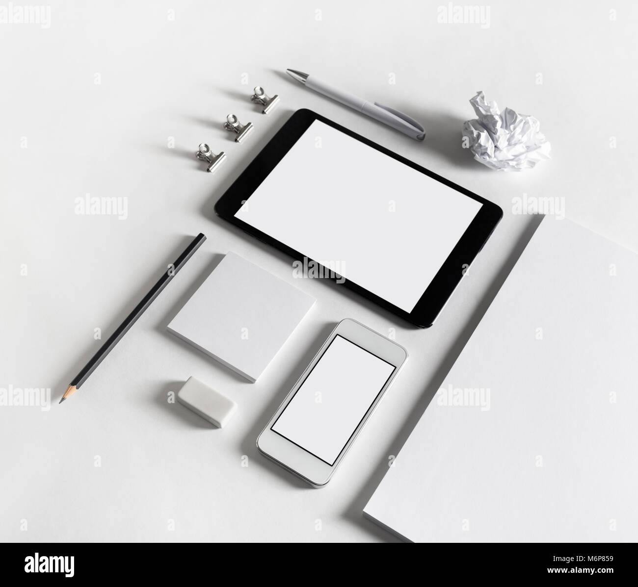 Photo of blank stationery and gadgets on paper background. Corporate ...