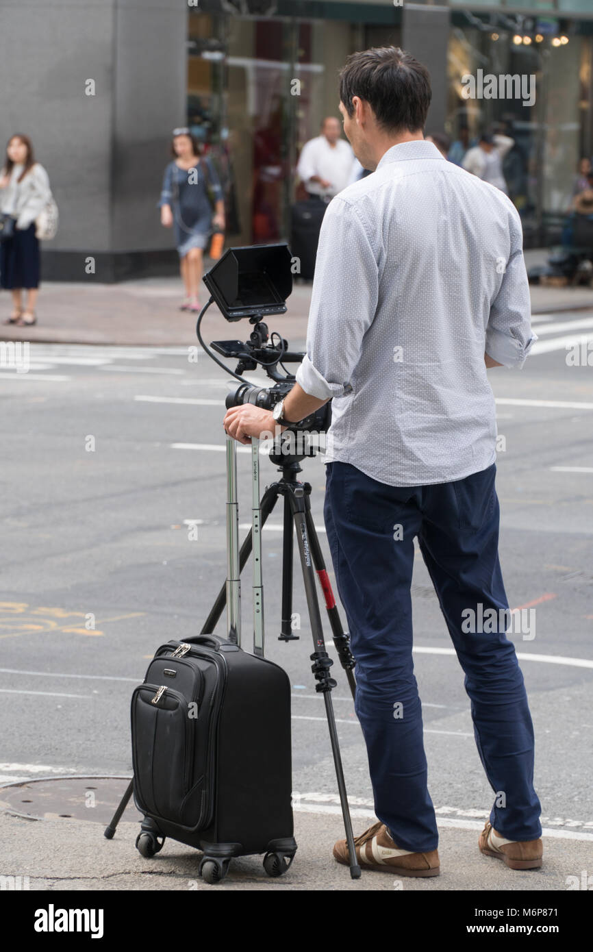 New York City, Circa 2017: Male photographer standing on New York City ...