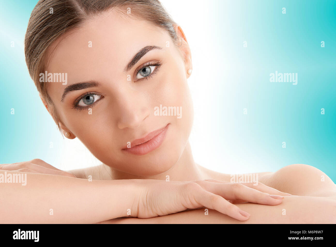 Close-up portrait of an attractive woman with perfect skin looking at ...