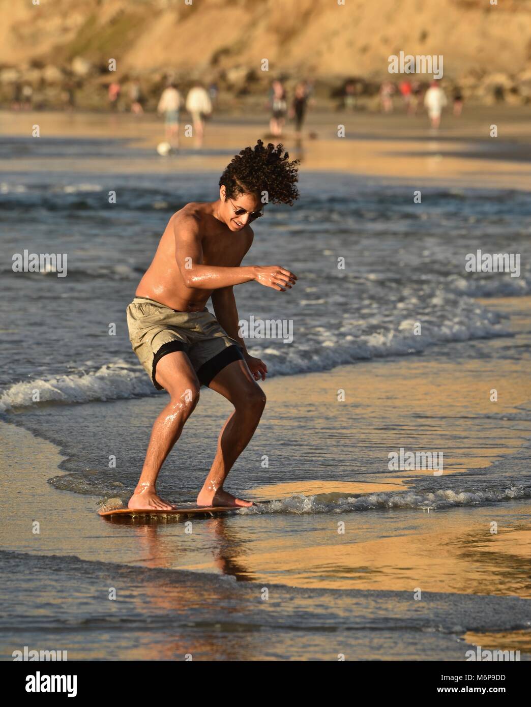 Young man ocean splash african hi-res stock photography and images - Alamy