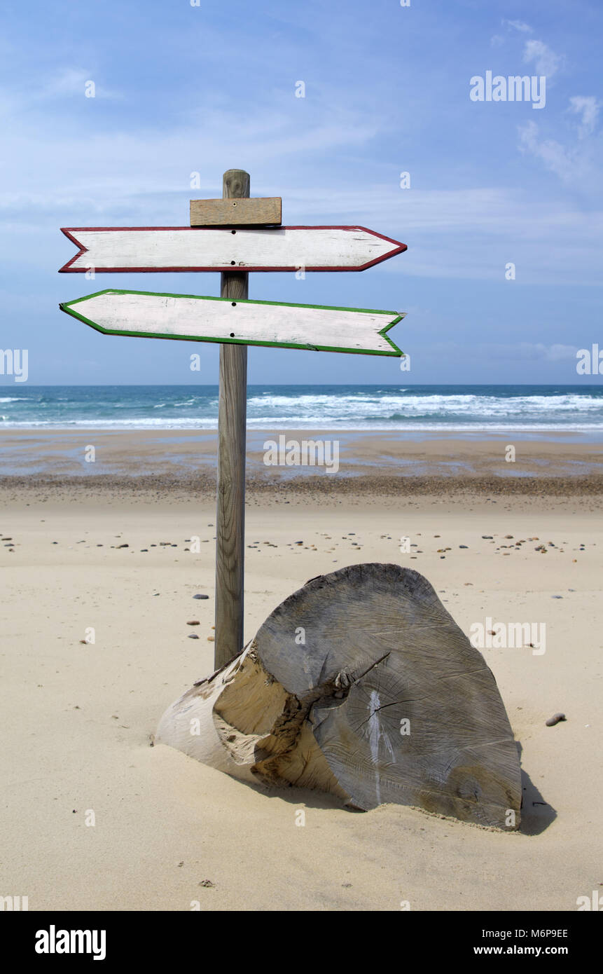 Double directional signs on a beach Stock Photo - Alamy