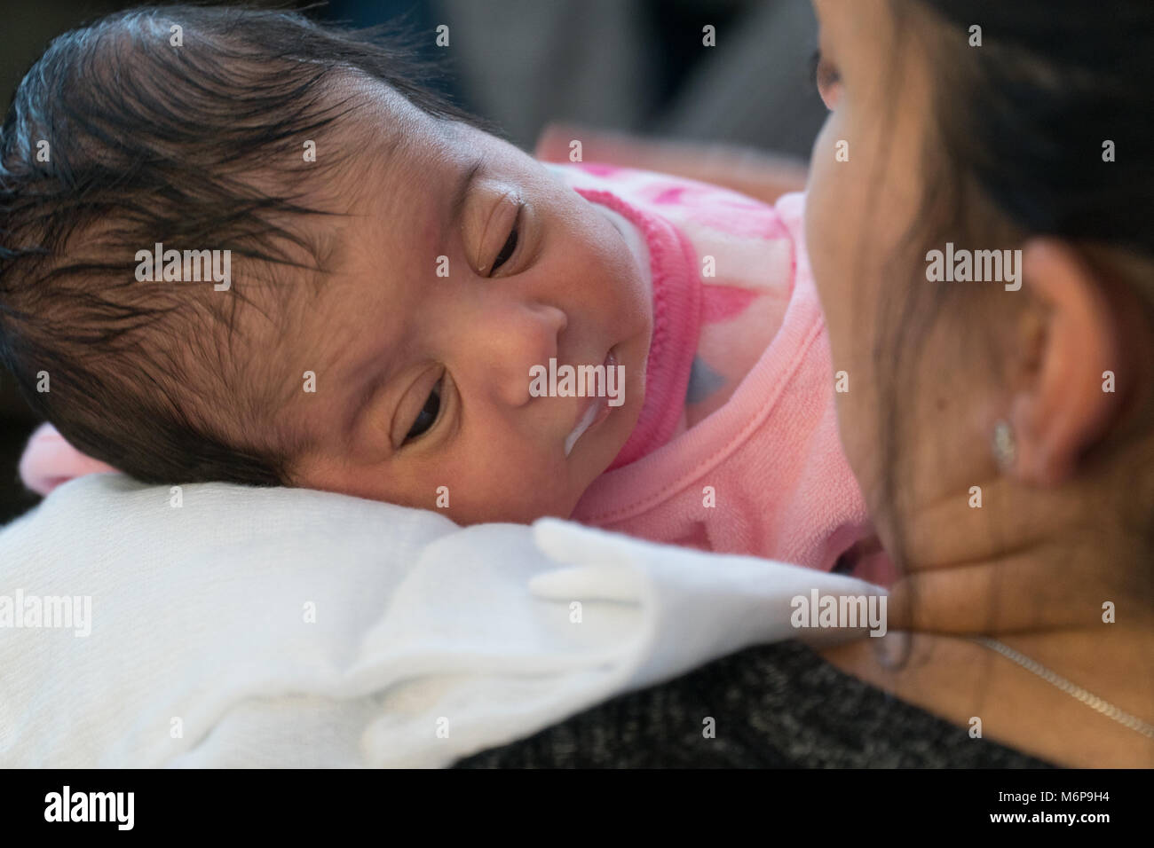 Adorable newborn baby girl drooling milk mustache after bottle formula ...