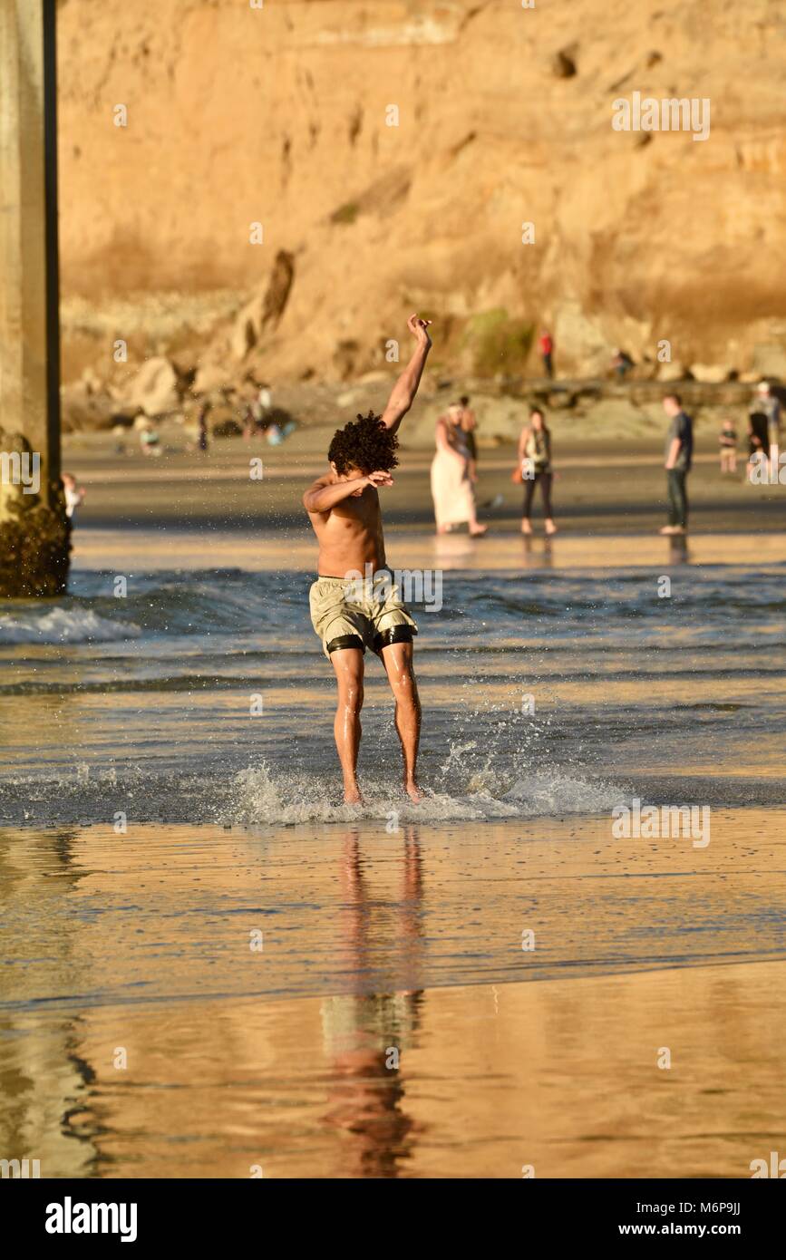 Young man ocean splash african hi-res stock photography and images - Alamy