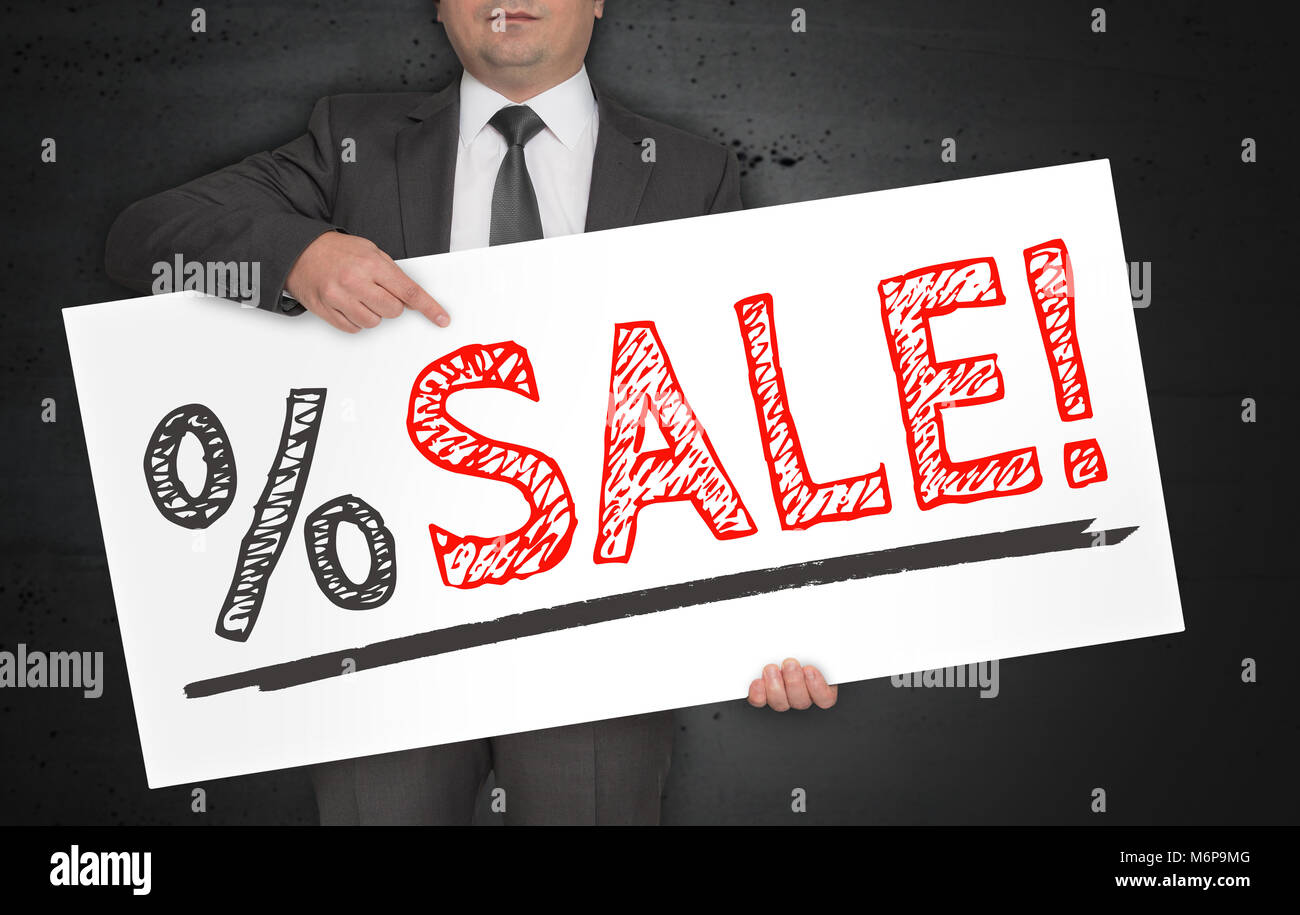 Sale poster is held by businessman Stock Photo - Alamy
