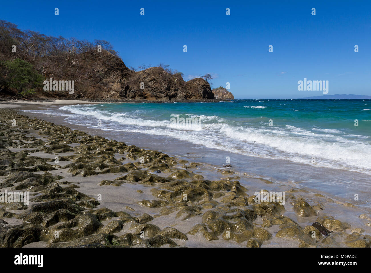 rocky shore line of this beautiful turquoise water beach in northern ...
