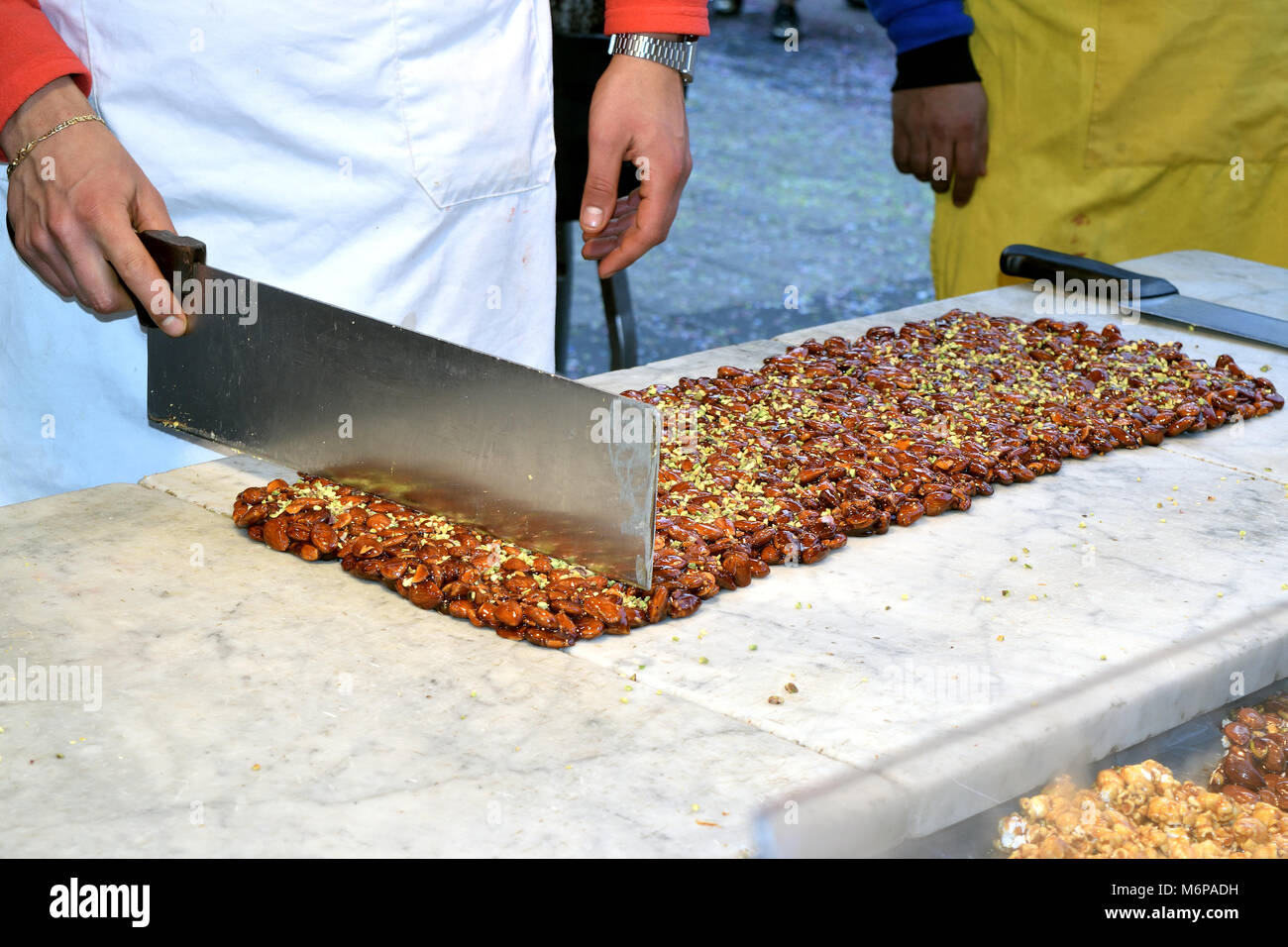 Stall with artisan preparing the traditional Sicilian torrone Stock ...