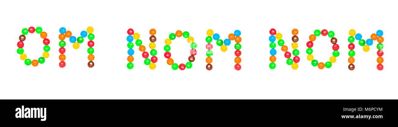 The text OM NOM NOM is written by sweet colorful chocolate candy ...