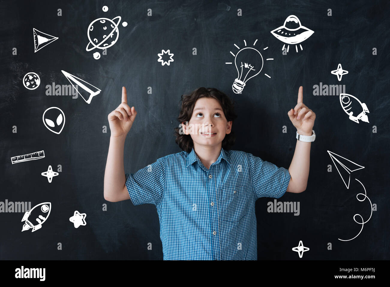 Emotional boy pointing to the sky while dreaming about exploring the ...