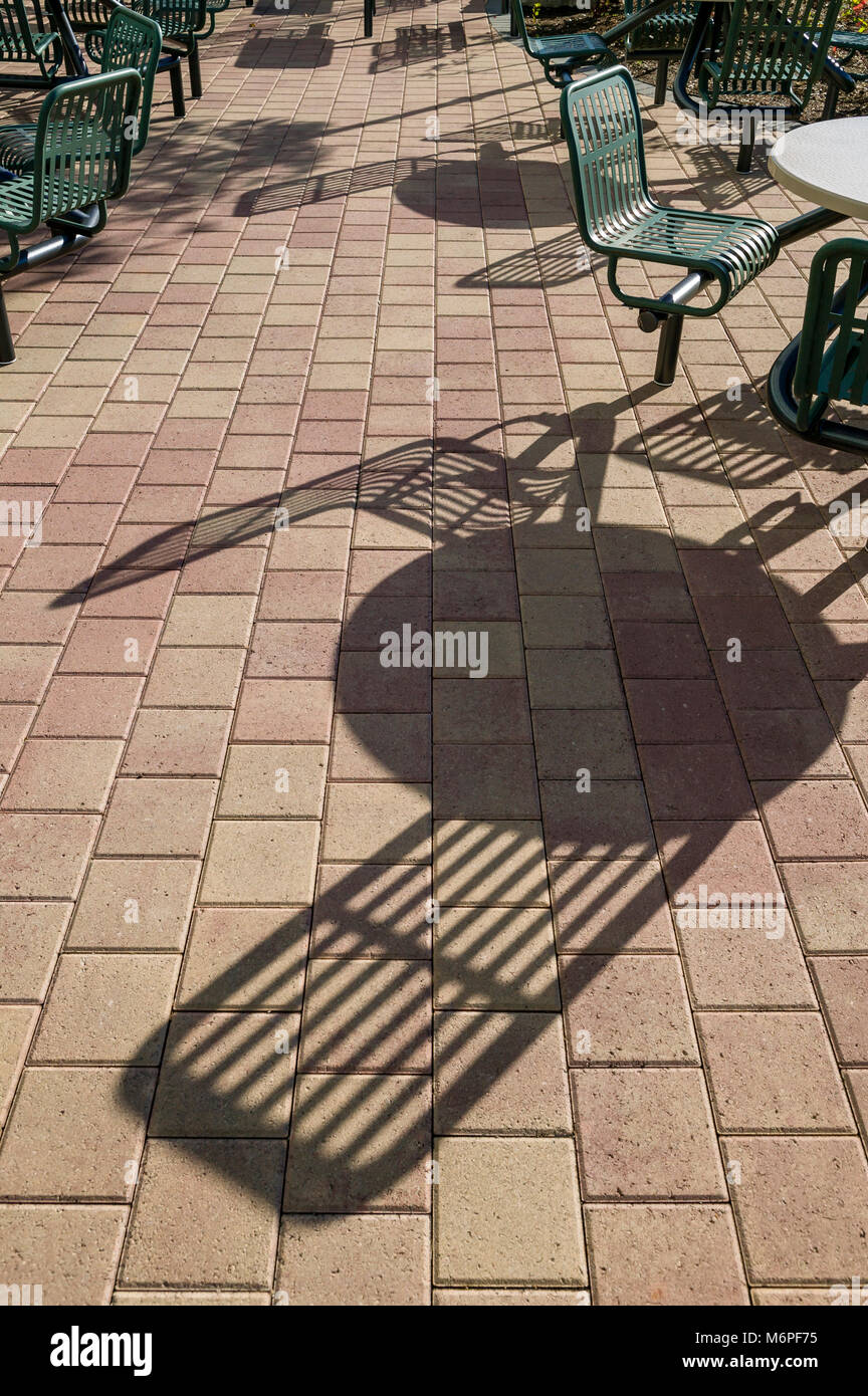 Interlock paving stone patio with outdoor furniture and long shadows ...