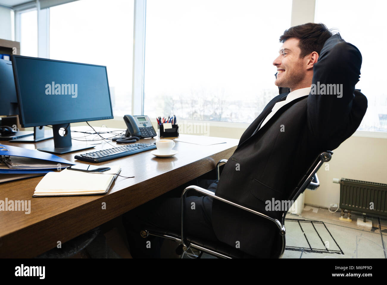 Businessman desk office leaning back hi-res stock photography and ...