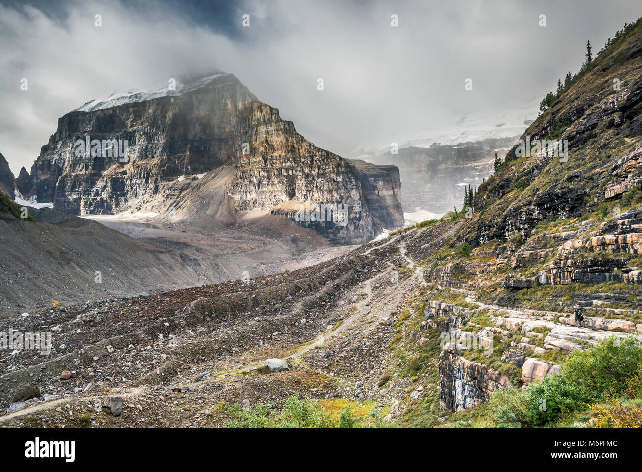 Hiker on Plain of the Six Glaciers Trail over Lower Victoria Glacier ...