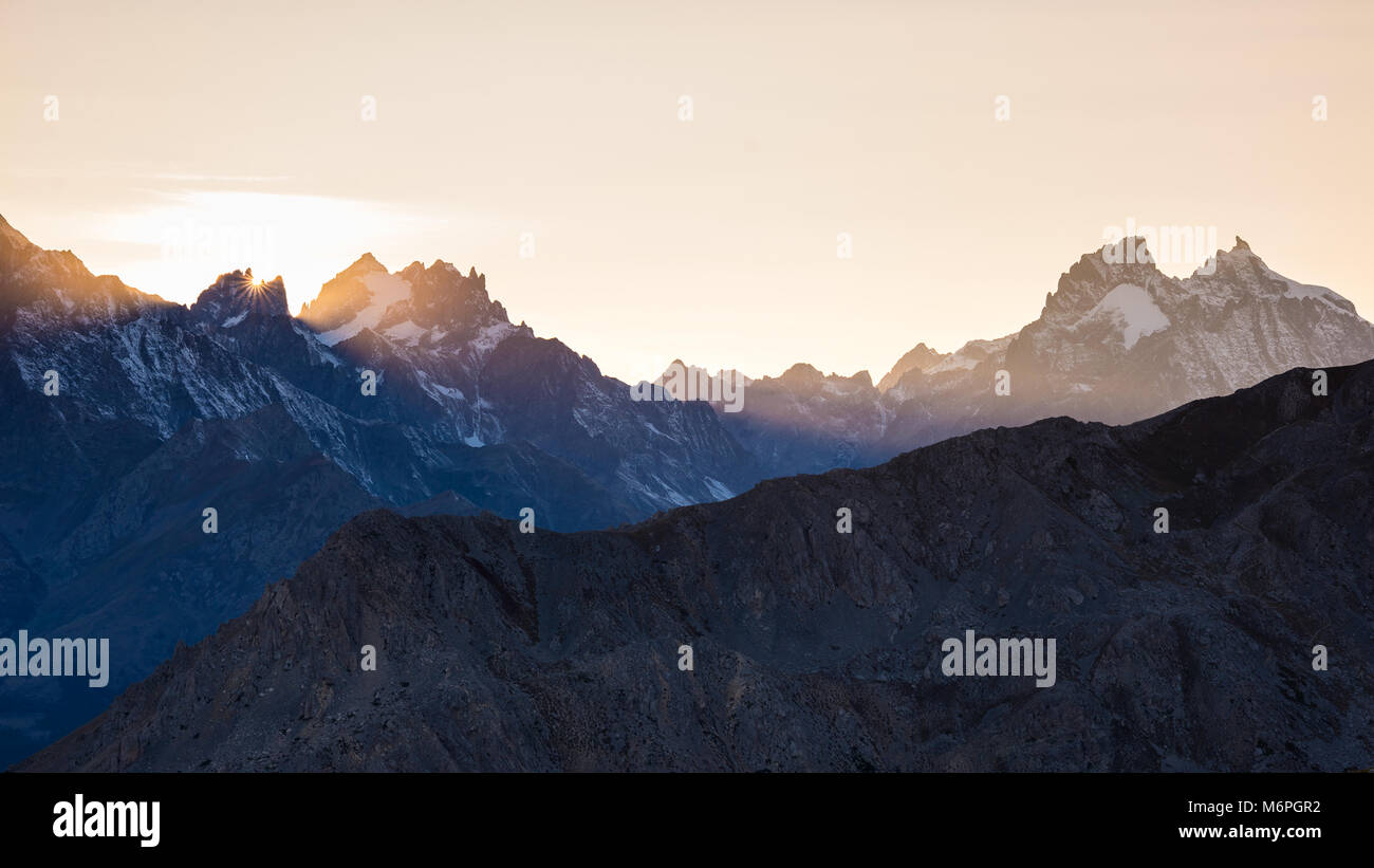 High altitude alpine landscape at dawn with first light glowing the ...