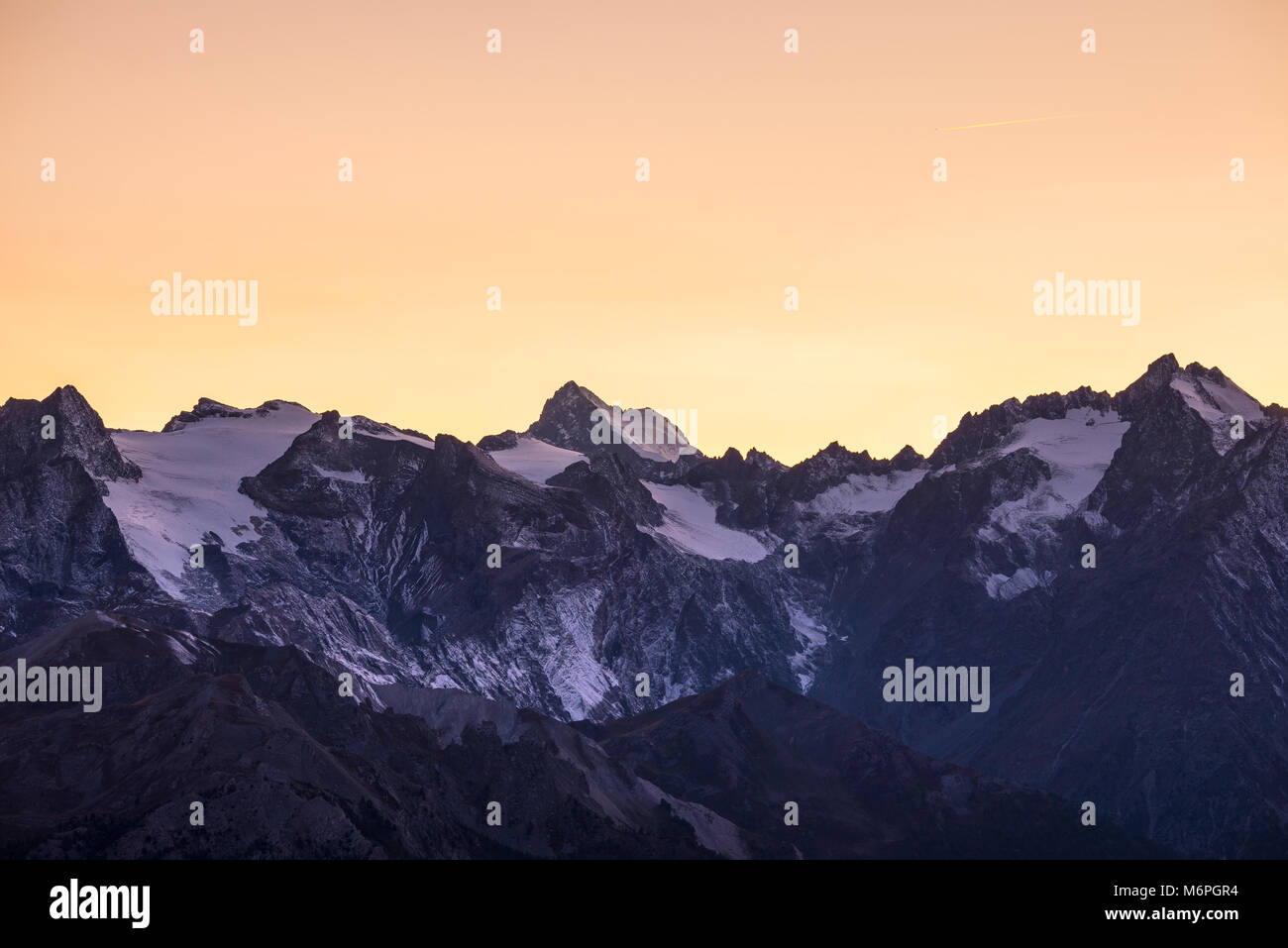 High altitude alpine landscape at dawn with first light glowing the ...