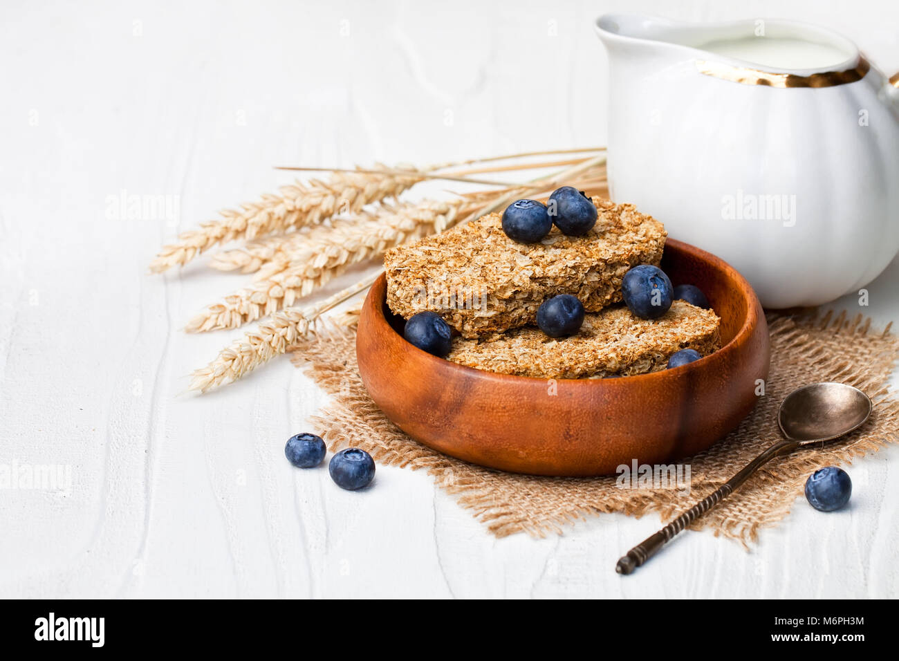 Wholegrain wheat bisks with milk and blueberry Stock Photo - Alamy