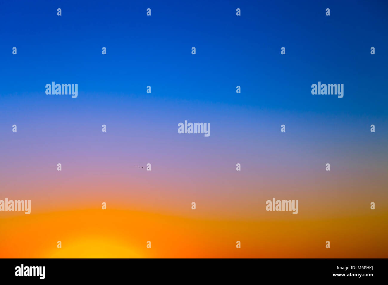 Background with gradient sunset sky in tones of yellow, orange and blue ...