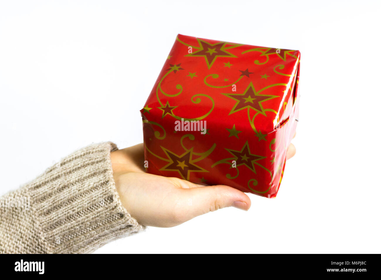 Female hands giving a Christmas gift isolated on white background Stock ...