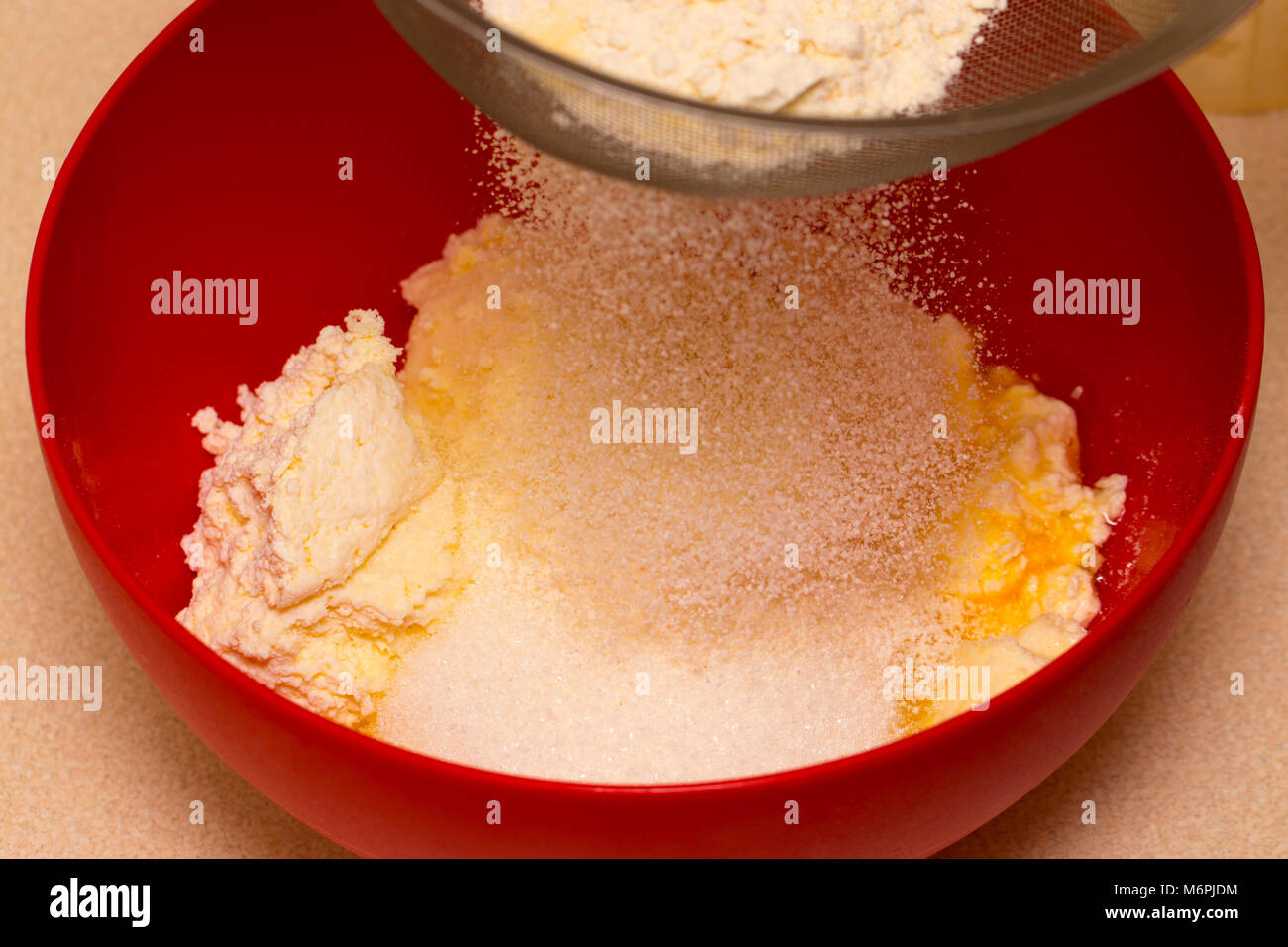 Flour sifting through a sieve for a baking Stock Photo - Alamy