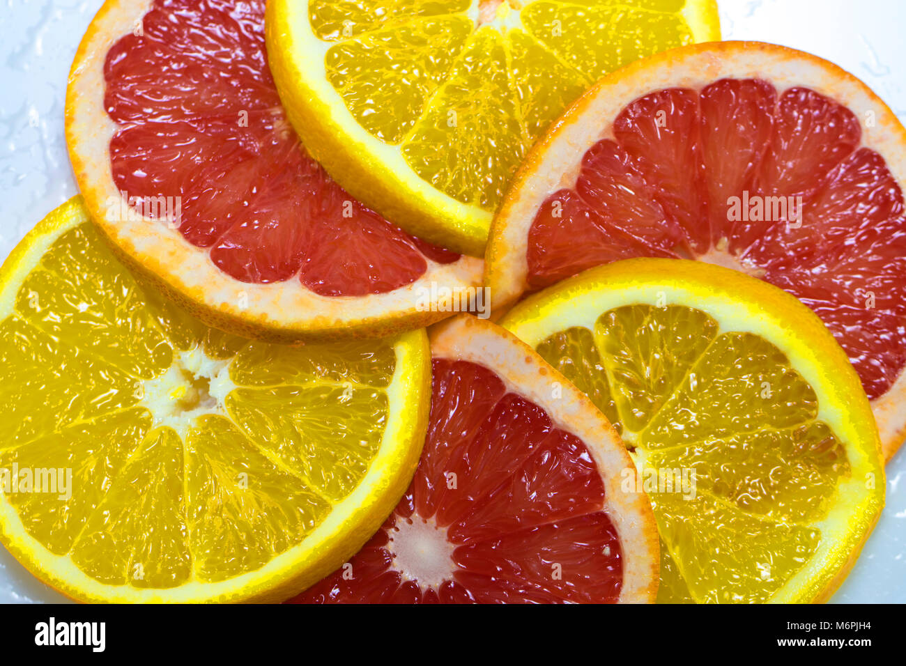 Juicy orange and grapefruit ring close-up as background Stock Photo - Alamy