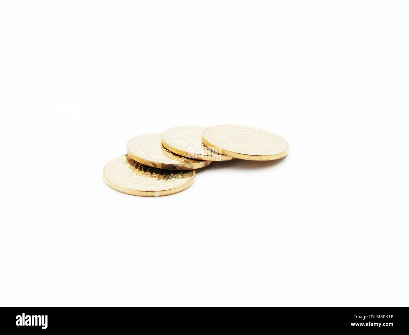 yellow coins on a white background isolation Stock Photo - Alamy