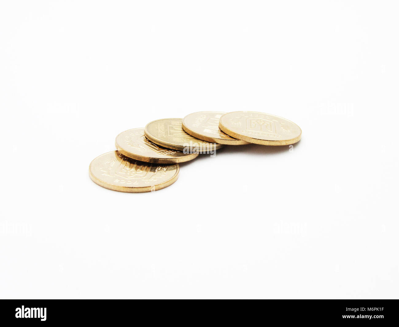 yellow coins on a white background isolation Stock Photo - Alamy