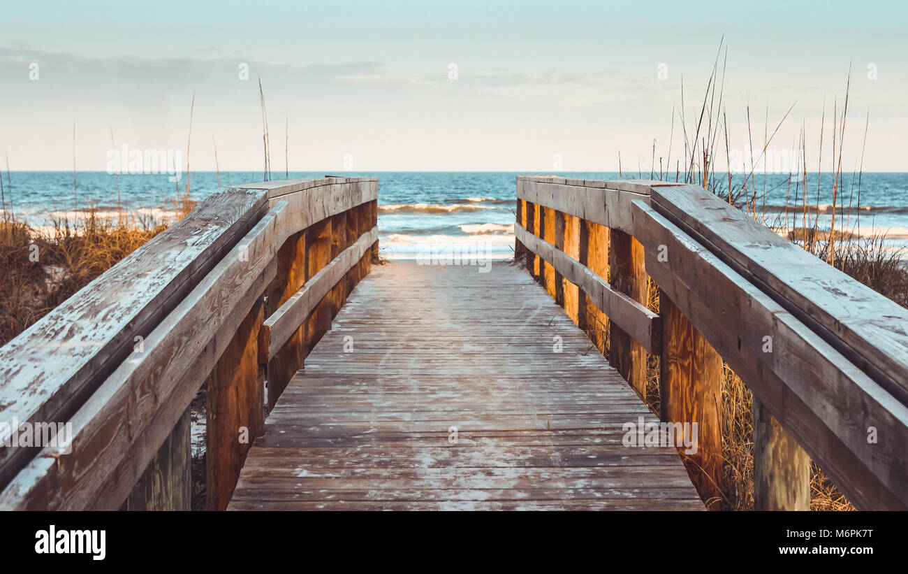 Wooden stairs to the beach with waves Stock Photo - Alamy
