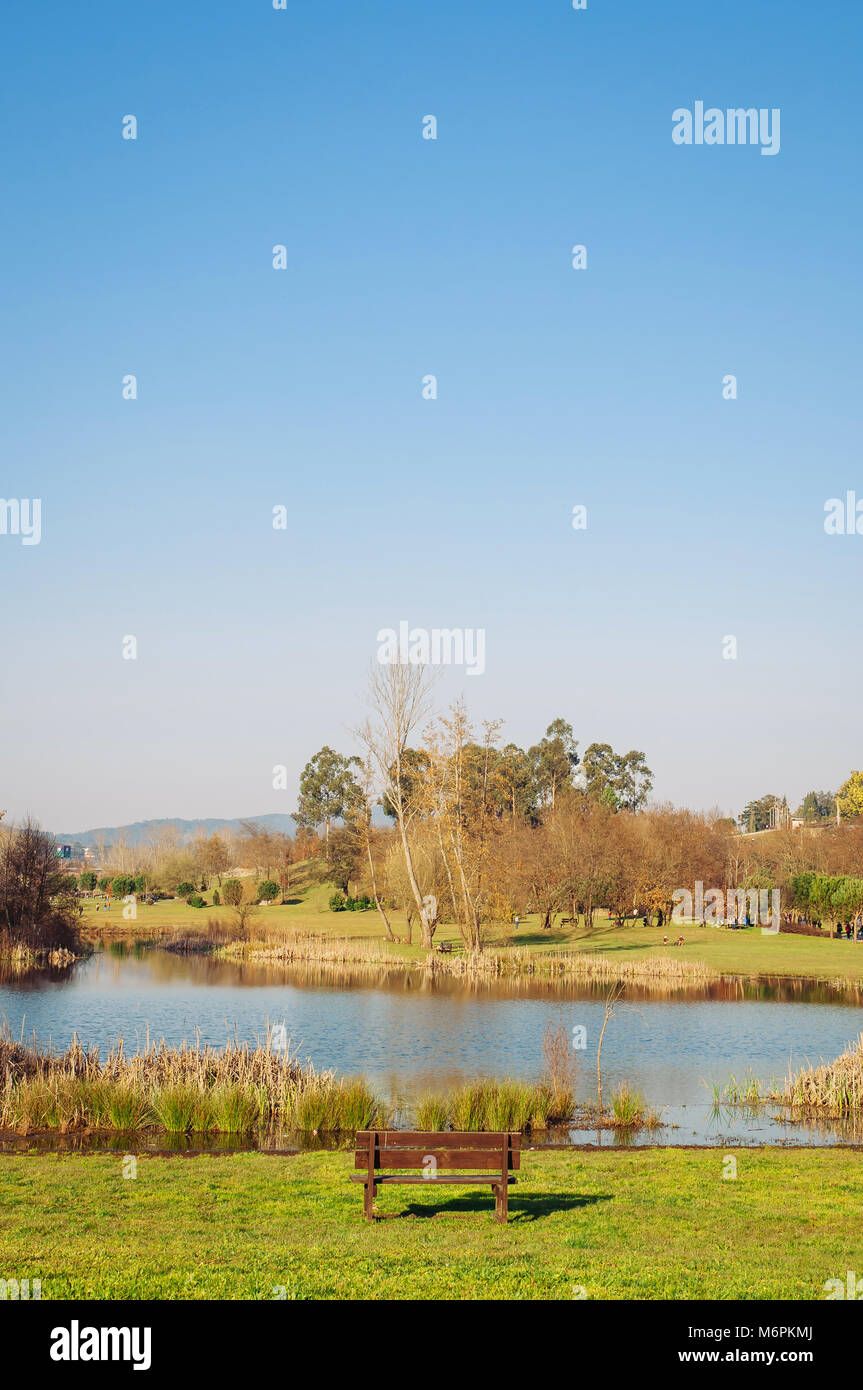 Single Empty Bench in a Park with Lake Stock Photo - Alamy