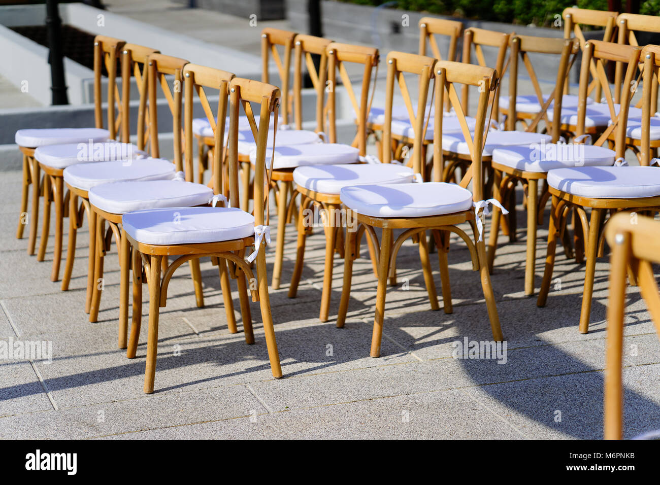Folding lawn chairs line up for wedding venue Stock Photo - Alamy