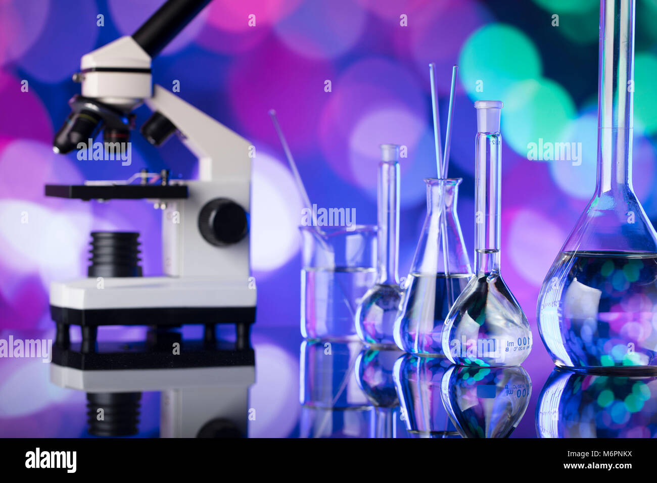 Science concept background. Microscope and laboratory glassware ...