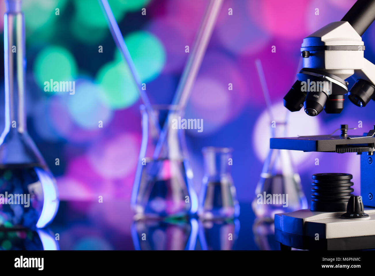 Science concept background. Microscope and laboratory glassware ...