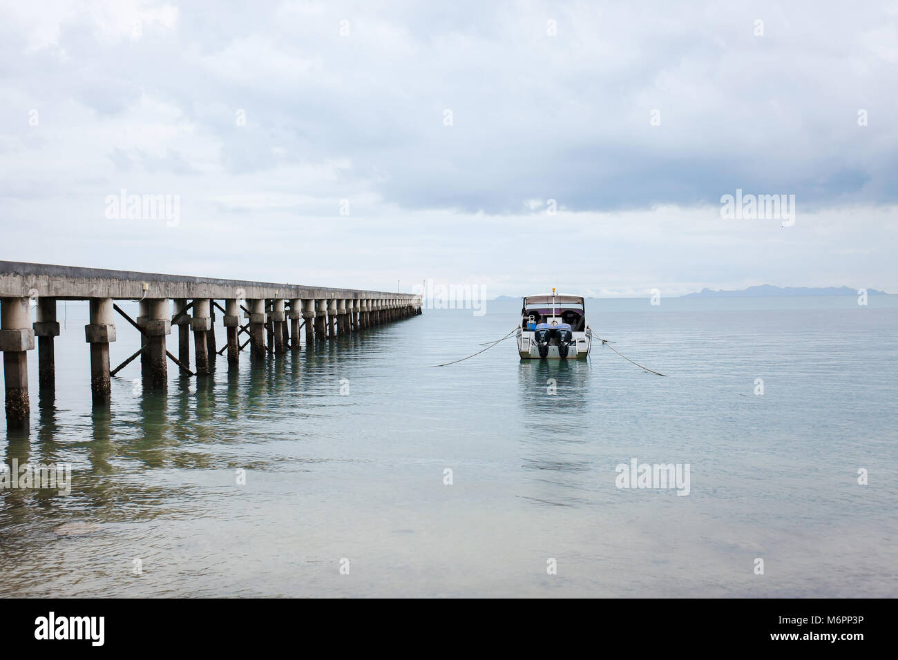 The long wooden pier with light cloud sky, The speed boat, before the ...